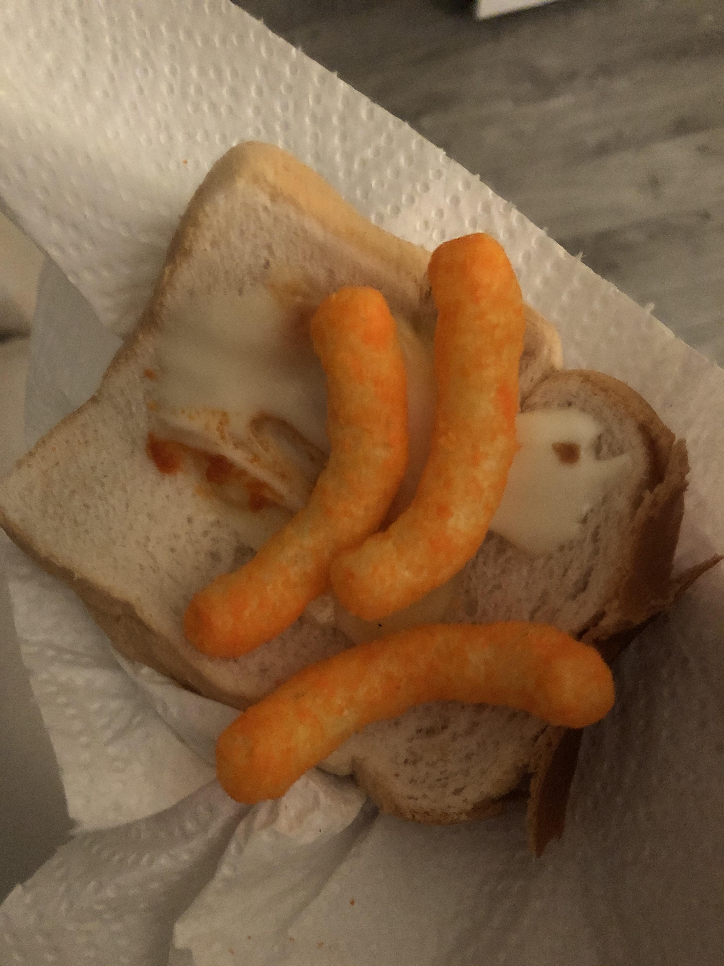 Toasted bread, melted mozzarella cheese, sriracha and cheetos | Scrolller