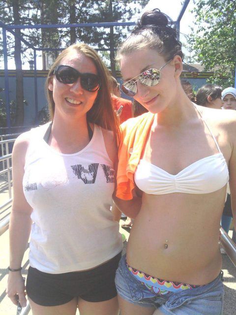 Took off her shirt and unzipped her shorts to cool off in line for the roller coaster | Scrolller