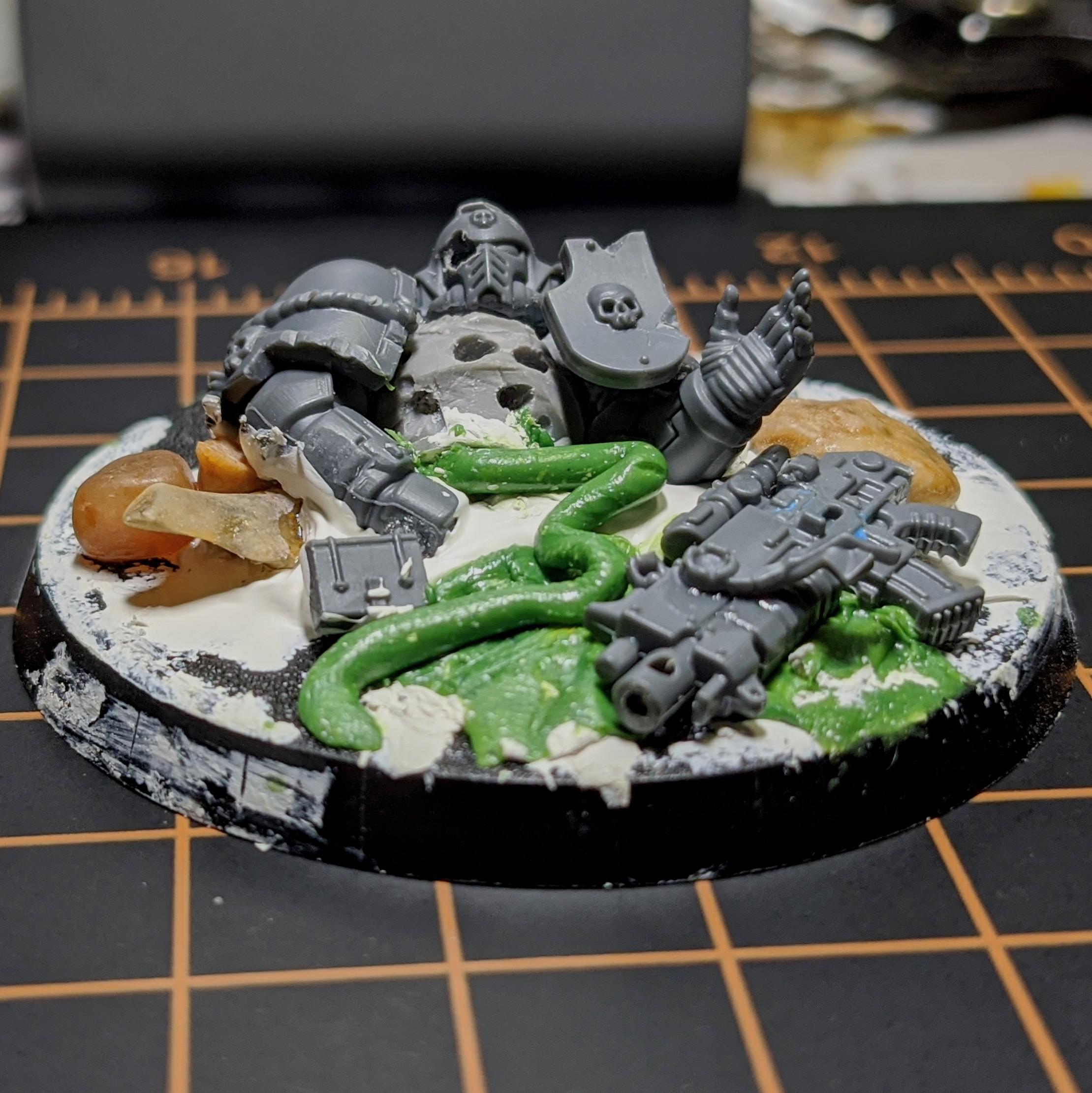 Using spare parts and putty to make a terrain piece/objective marker/diorama. | Scrolller