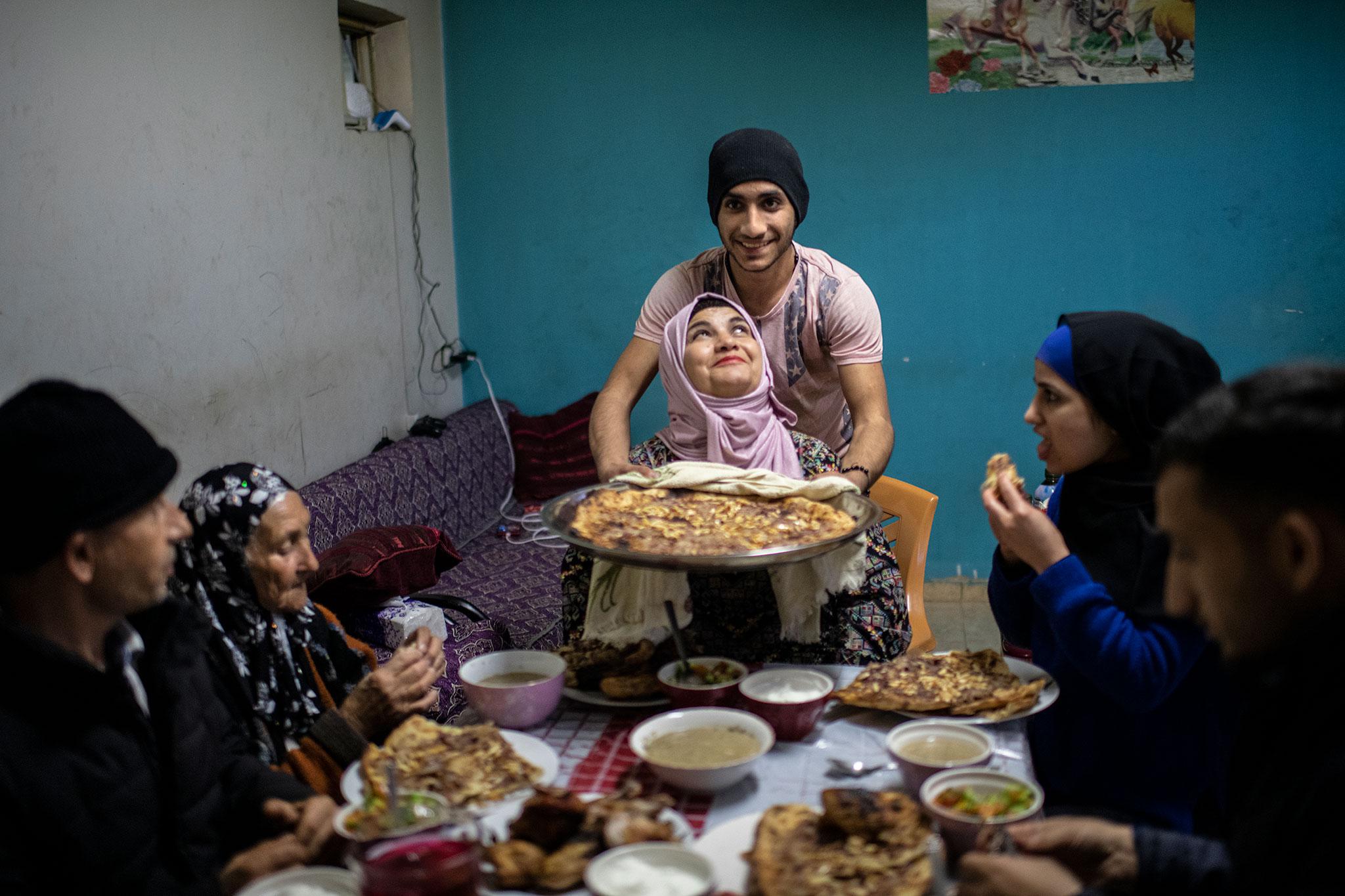 Wahbi Tanatra, a mother of eight, prepares to break her fast with her family in the West Bank ...