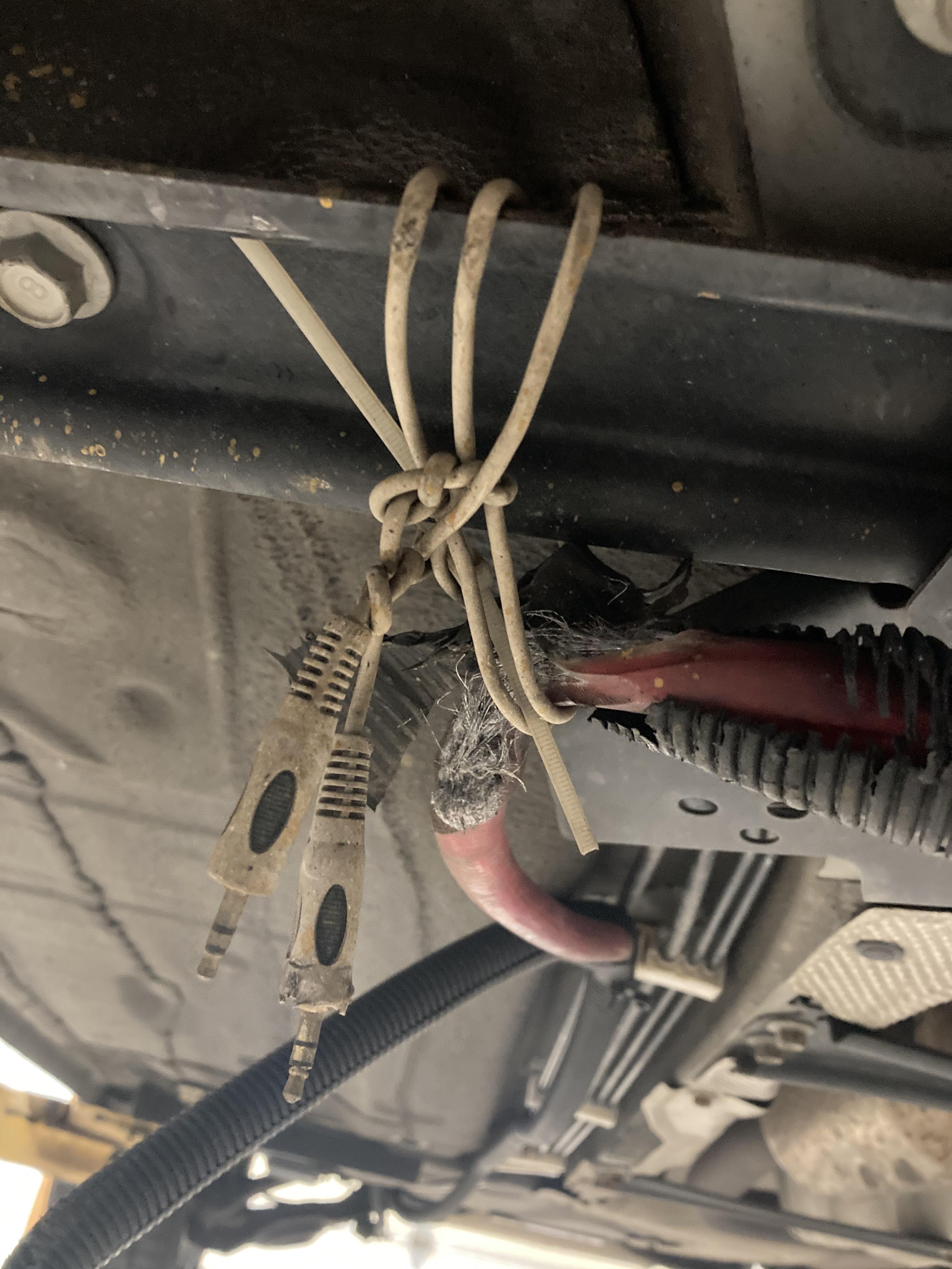 Yes that’s a live wire. Yes that’s an aux cord holding it up. No it didn’t pass inspection ...