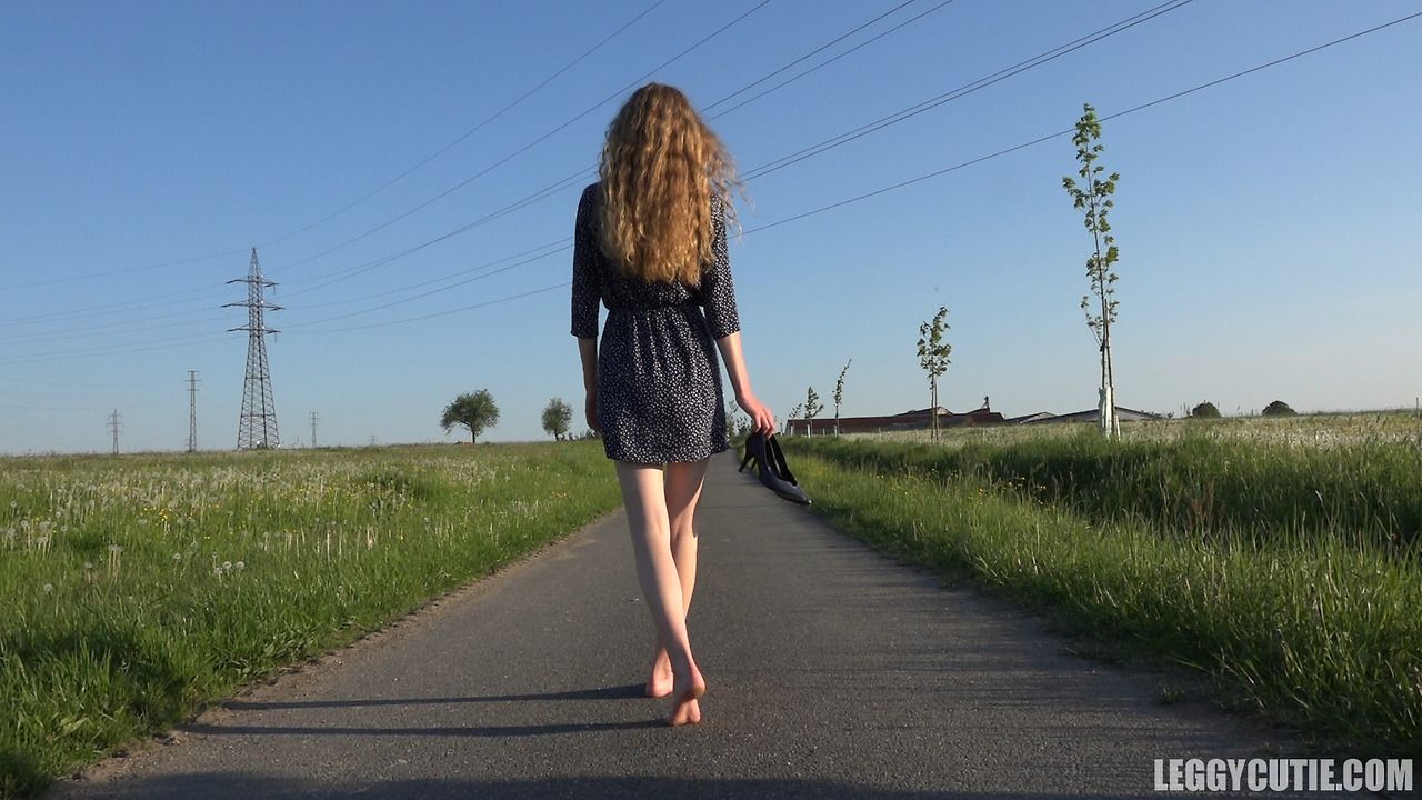 Young Girl Walking Barefoot On The Road | Scrolller