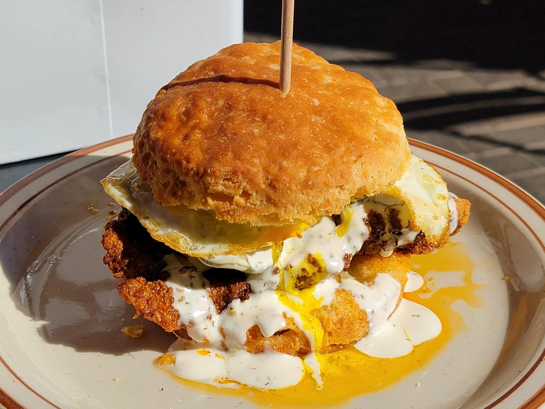 Nashville hot chicken, pickles, ranch, and a fried egg on a buttery biscuit. | Scrolller