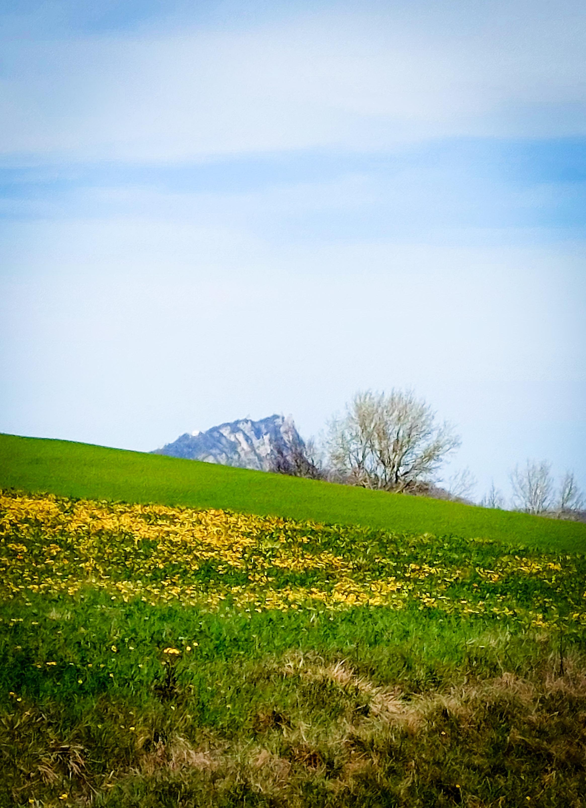 Mount Titan of San Marino Republic appears behind Italian countryside | Scrolller