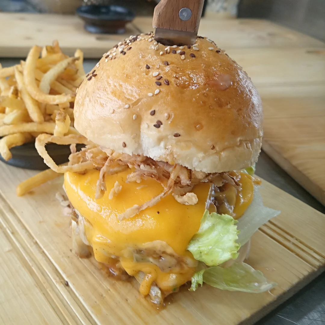 Extra cheesy cheddar burger topped with fried onions | Scrolller