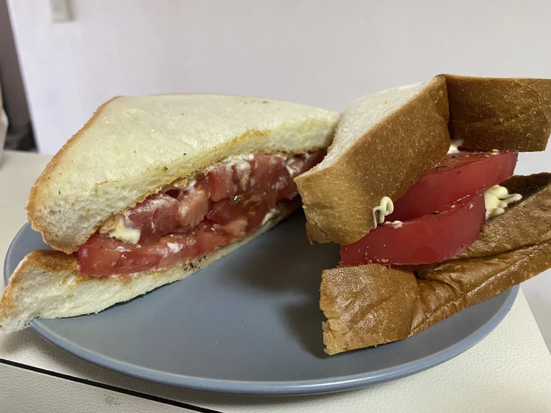 Fresh tomato sandwich on in-side-toasted Japanese milk bread with kewpie mayo, salt and black ...