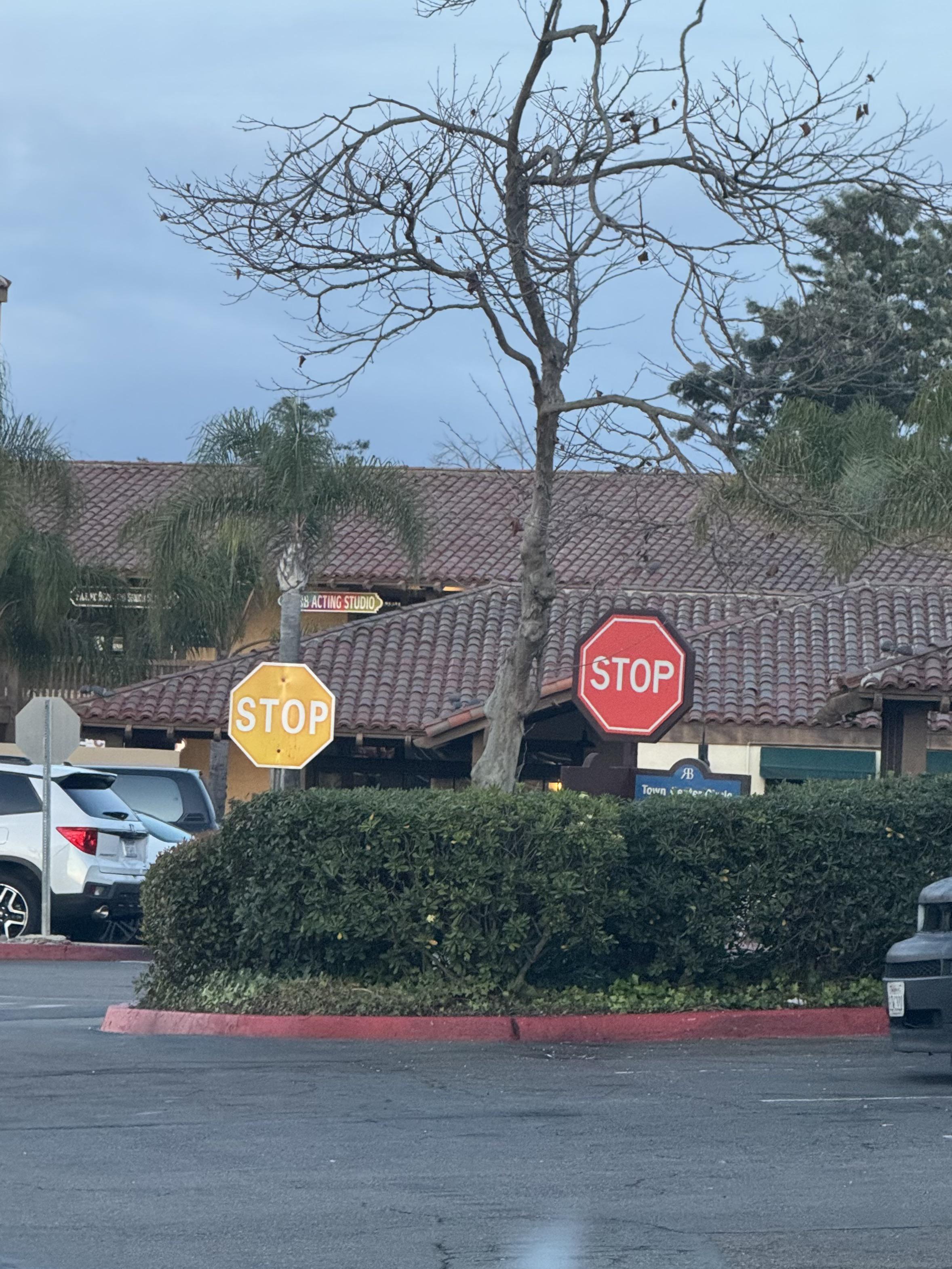 Two abnormal stop signs next to each other. | Scrolller
