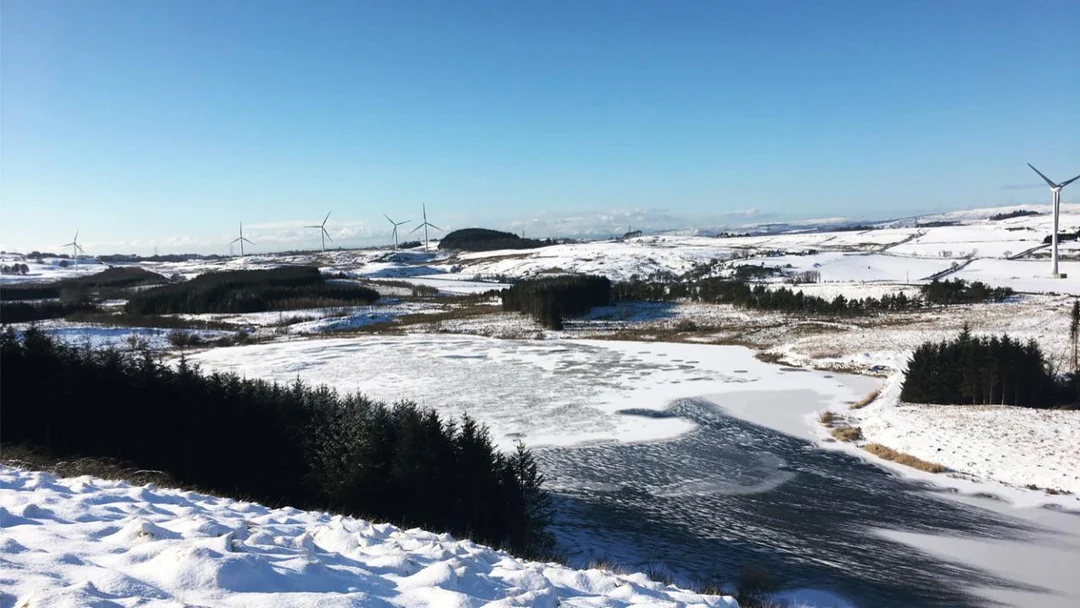 Frozen lake & snowy hills | Scrolller
