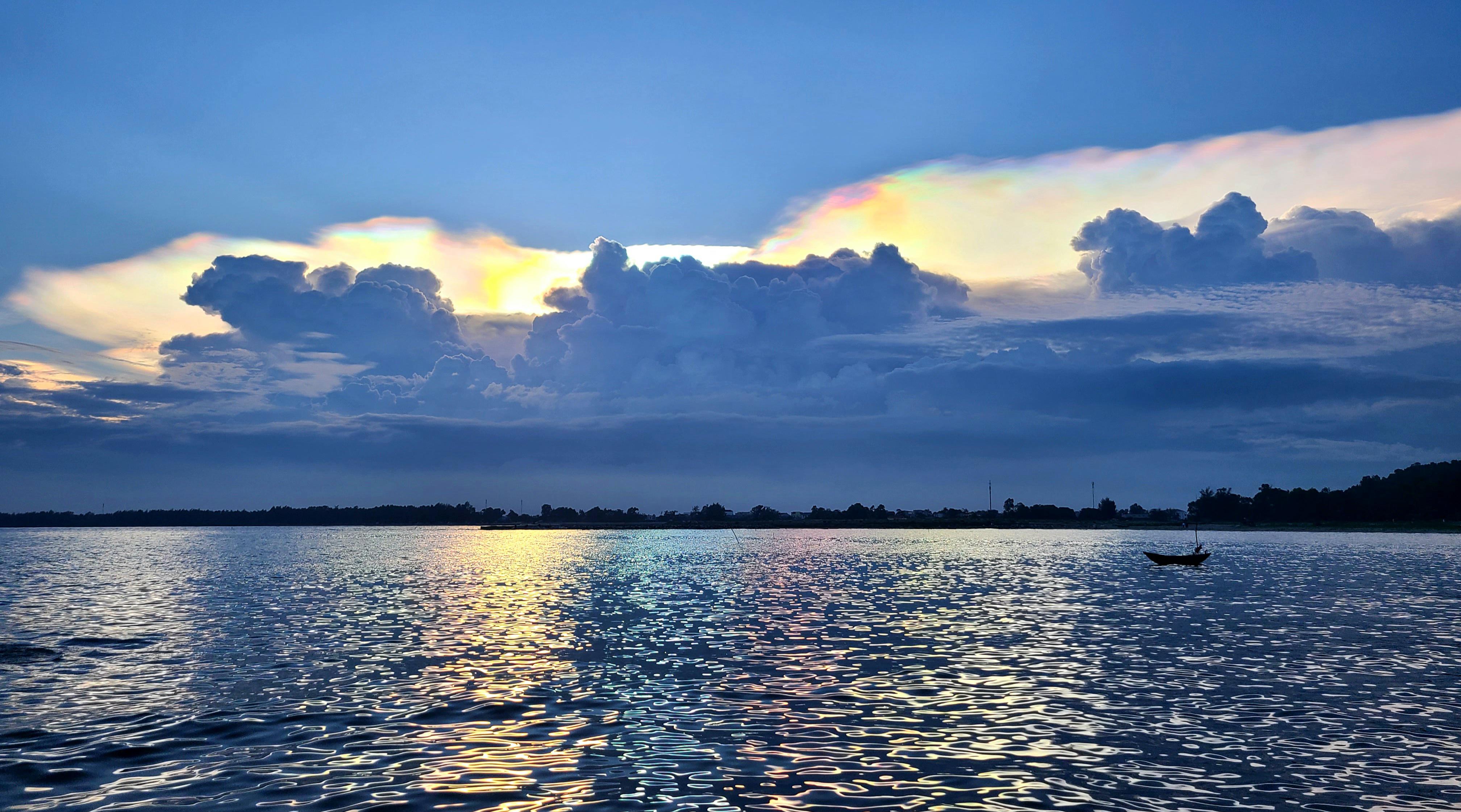 Rainbow clouds reflecting on water in Vietnam | Scrolller