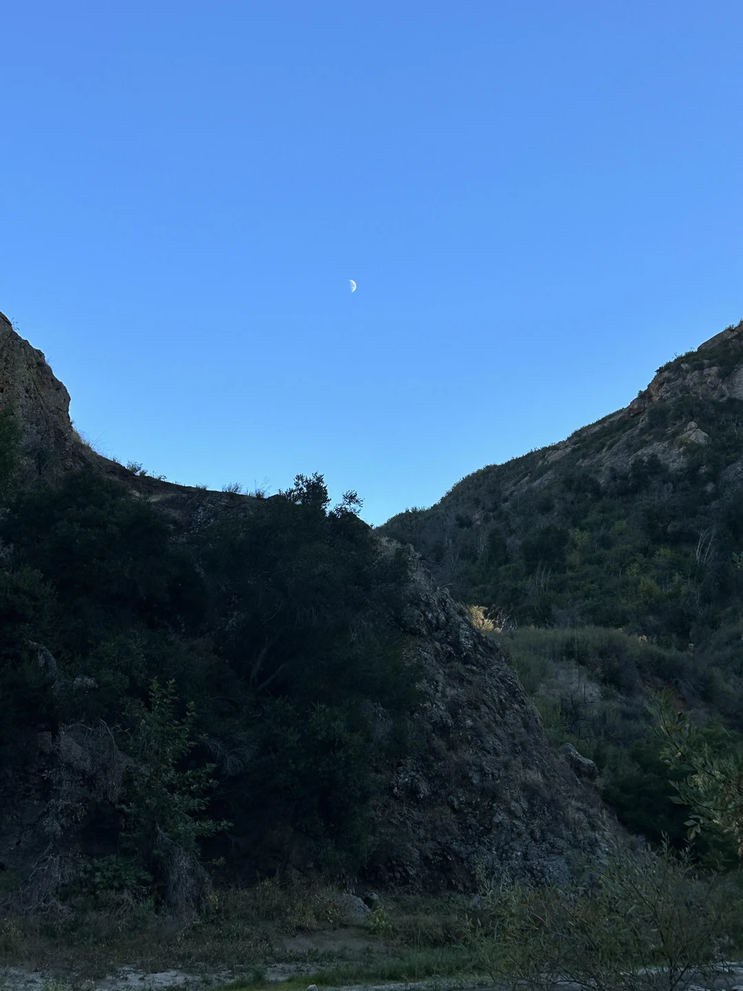 The moon behind these mountains taken at Malibu creek | Scrolller