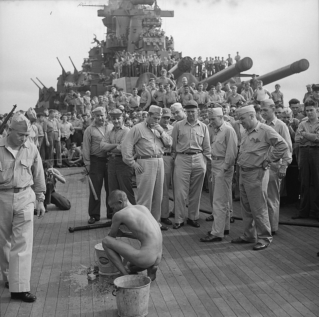 The crew of the battleship ”New Jersey" and a captured, shot down Japanese kamikaze pilot, whom ...