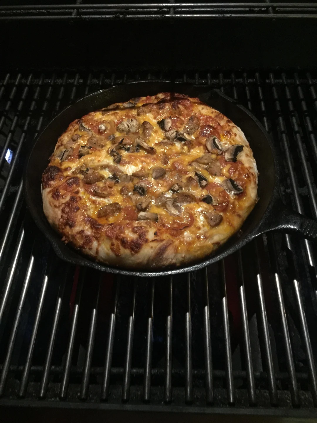 Cast iron pizza on a Weber grill. | Scrolller