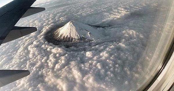 Japan's highest mountain, Mount Fuji, cutting through the clouds | Scrolller
