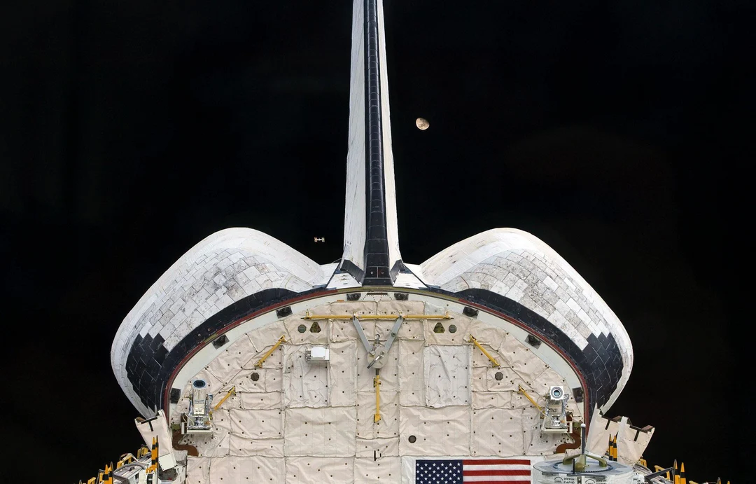 Amazing view of the Moon and the ISS beyond the open payload bay and tail of Space Shuttle ...