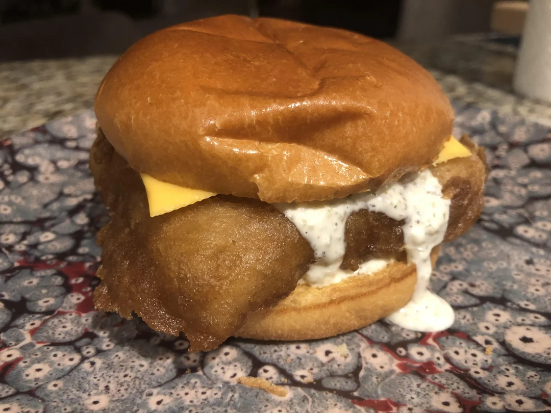 Homemade simple McD’s style fish sandwich. Battered cod, gubment cheese, homemade tartar on ...