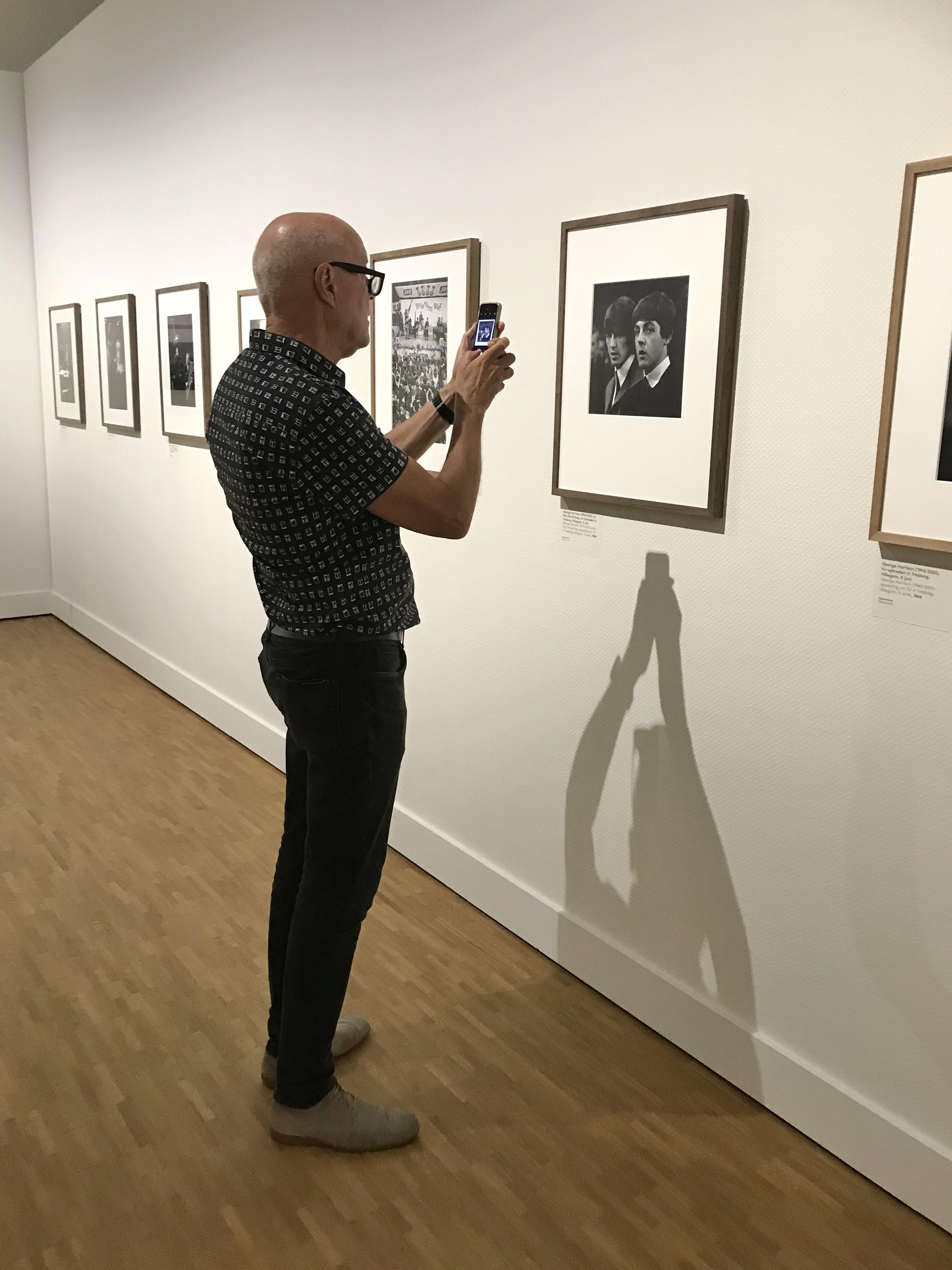 A photo of someone taking a photo of a photo of the Beatles | Scrolller