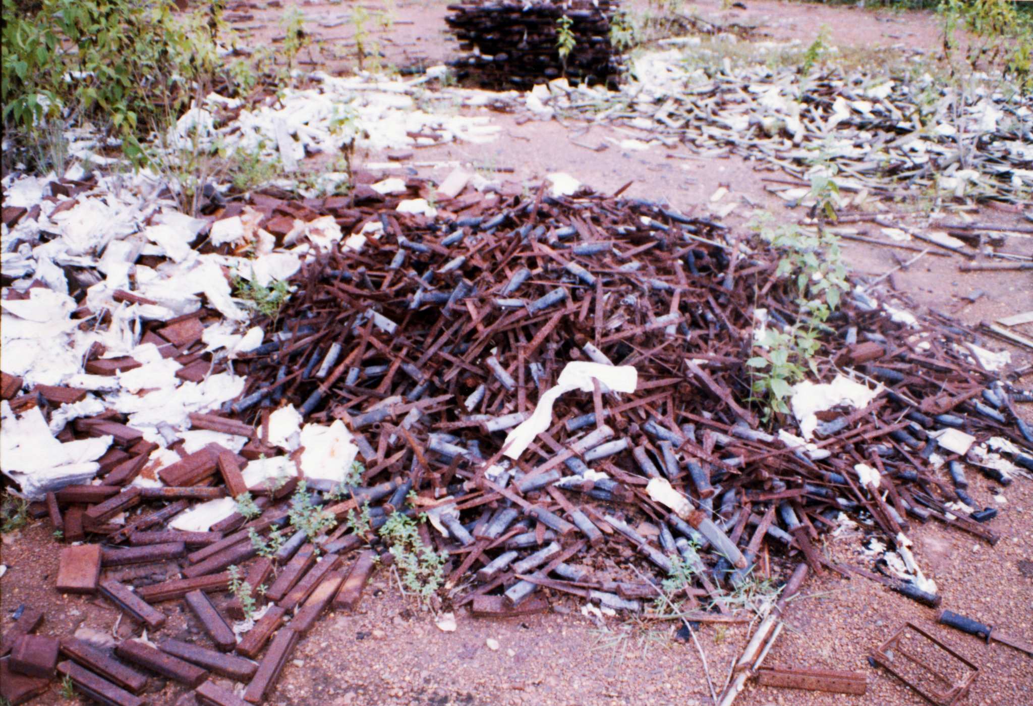 A huge outdoors weapons dump in Vietnam, back in the 80s. Thompsons, mausers, .50 cal, many more ...