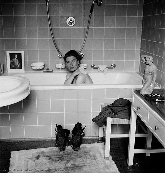 War Correspondent, photographer, and model Lee Miller washing off the mud from Dachau ...