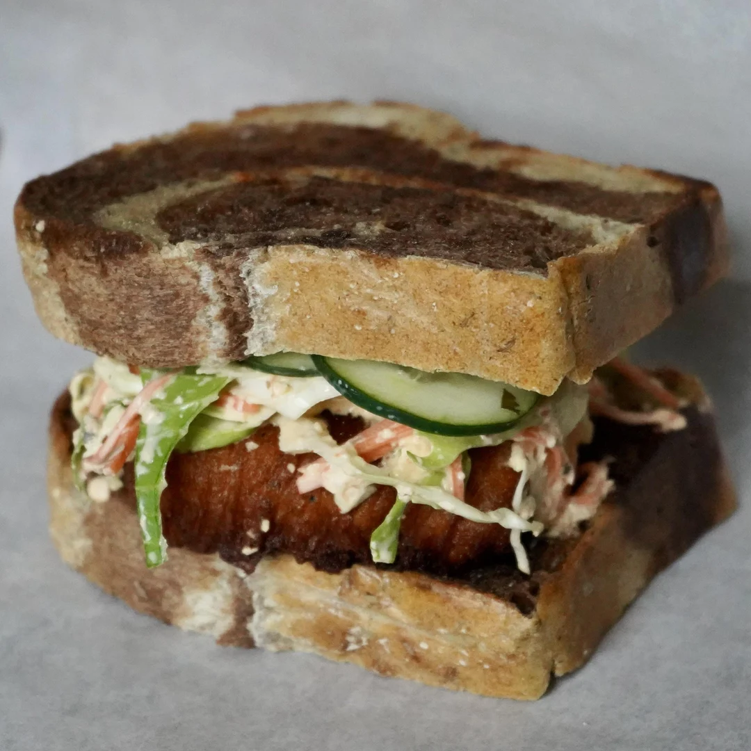 Fried Cod with Russian slaw and spicy pickles on homemade marble rye | Scrolller