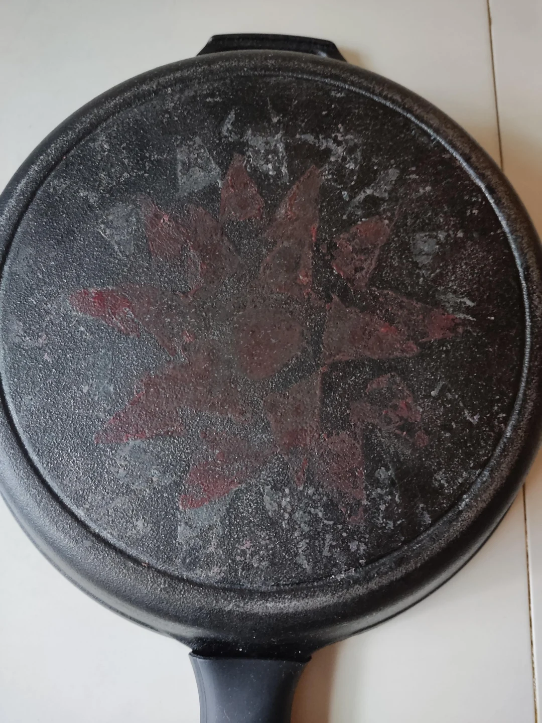 Accidentally placed my cast iron on a supposedly cloth mat but now plastic has burned into it ...