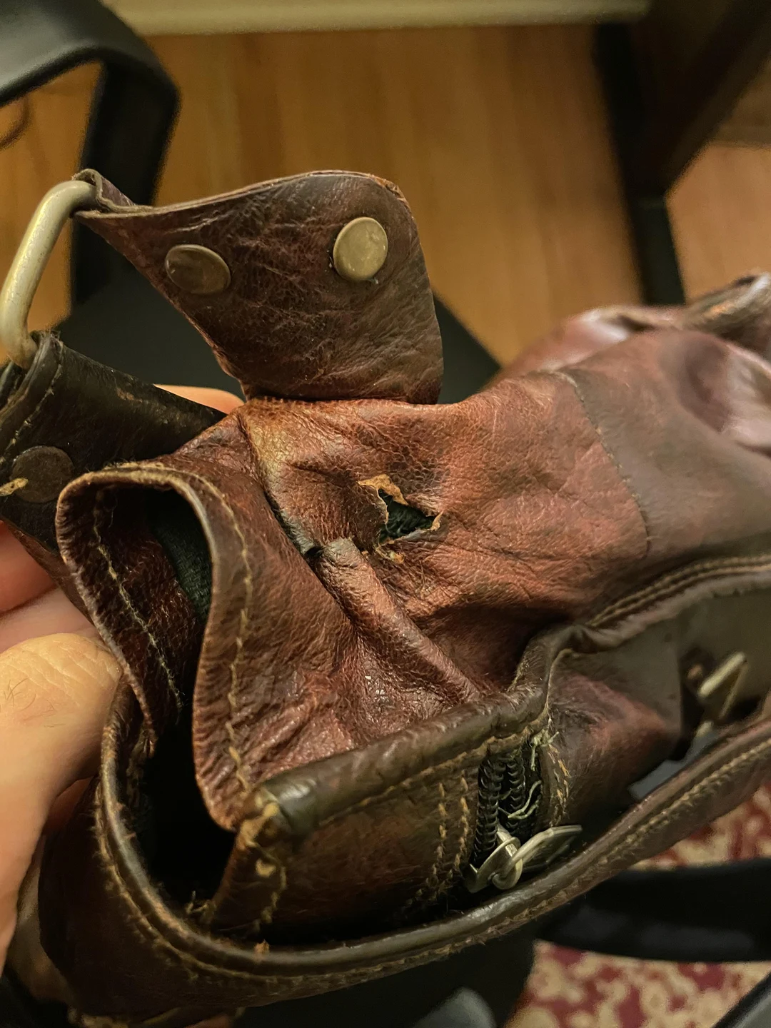 Anyone know how to fix this? Two of these nails(?) came out of the bag. Stayed on the strap ...