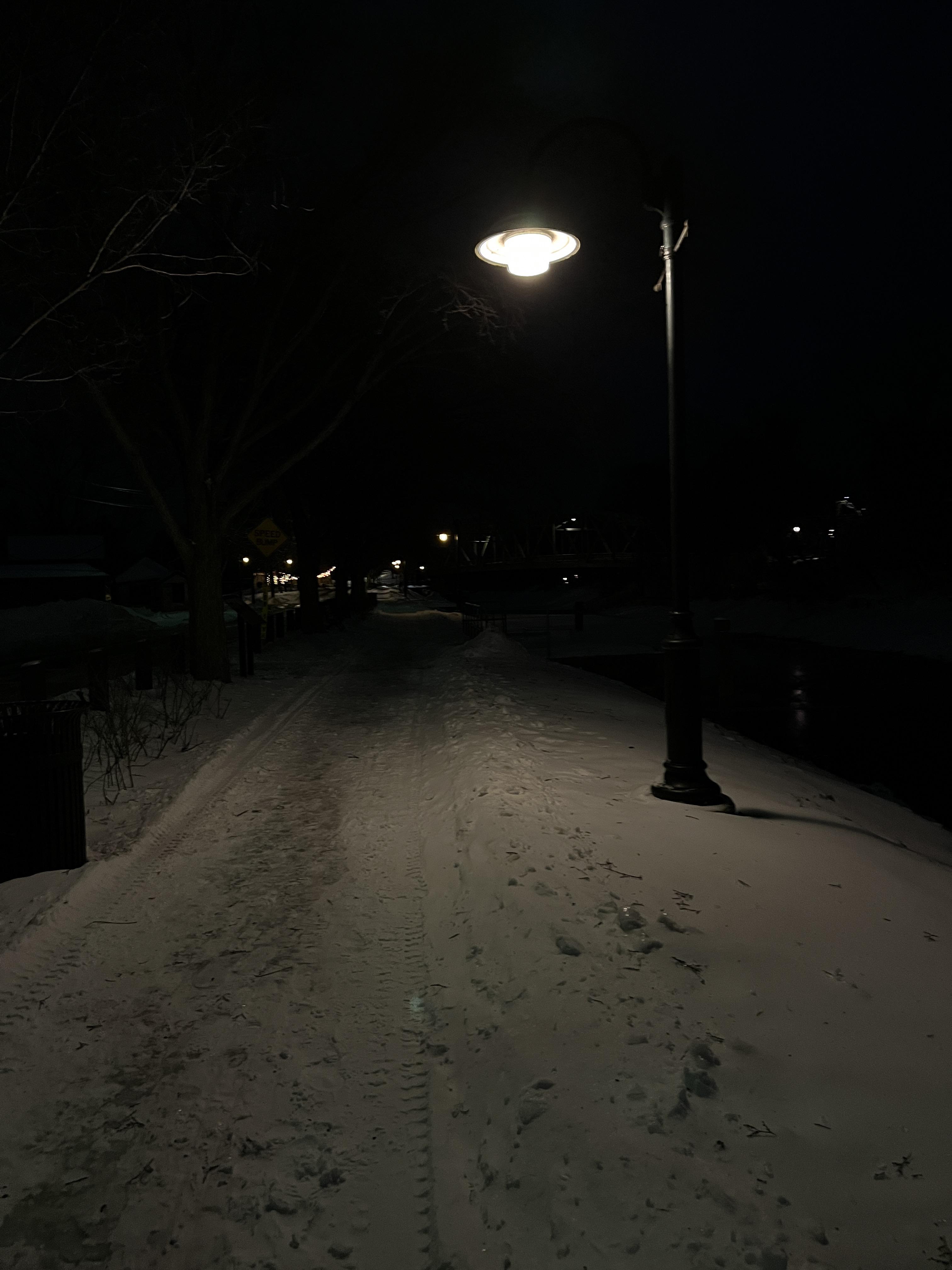 Snowy walk on a lit path | Scrolller