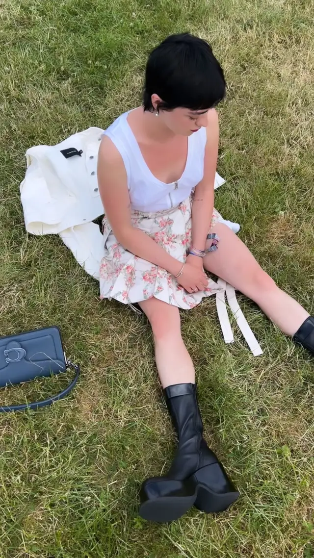 Maisie sitting on grass | Scrolller