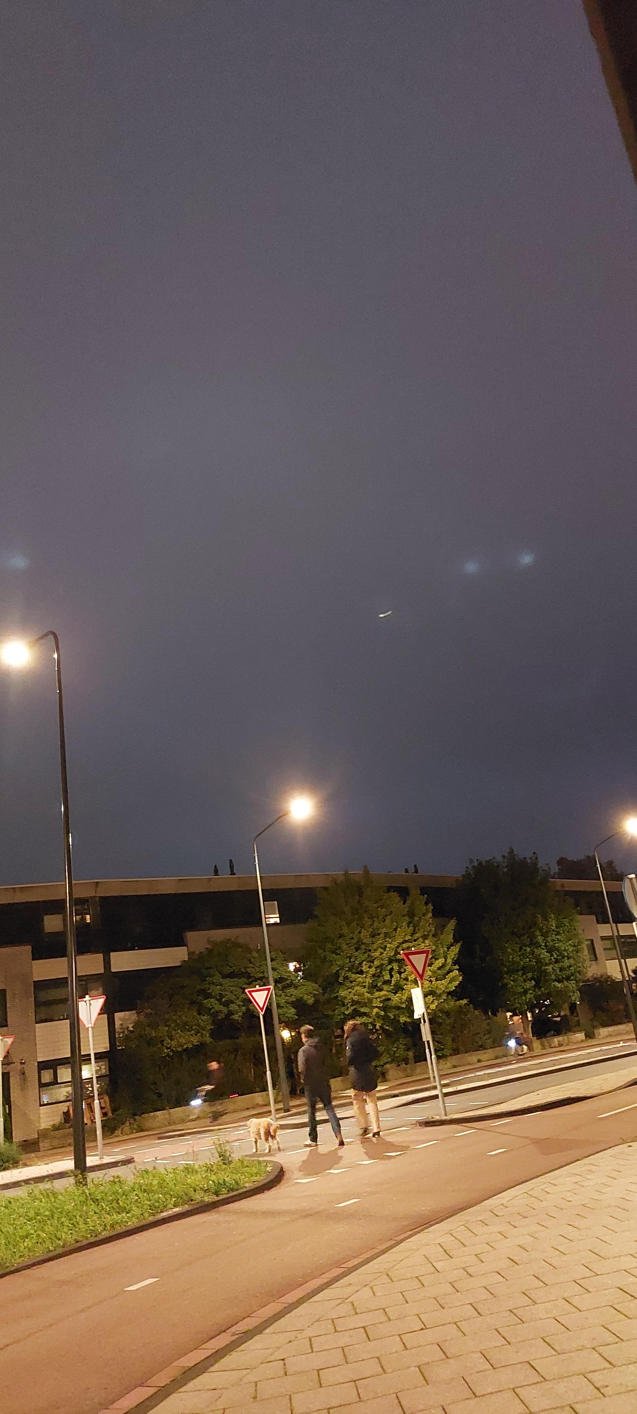 What are these flying flashlight like lights in the clouds? | Scrolller