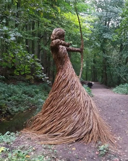 A huntress sculpture in the forest woven from willow branches | Scrolller