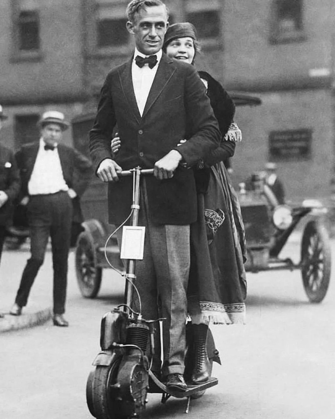 Couple posing on their electric scooter, 1923 | Scrolller