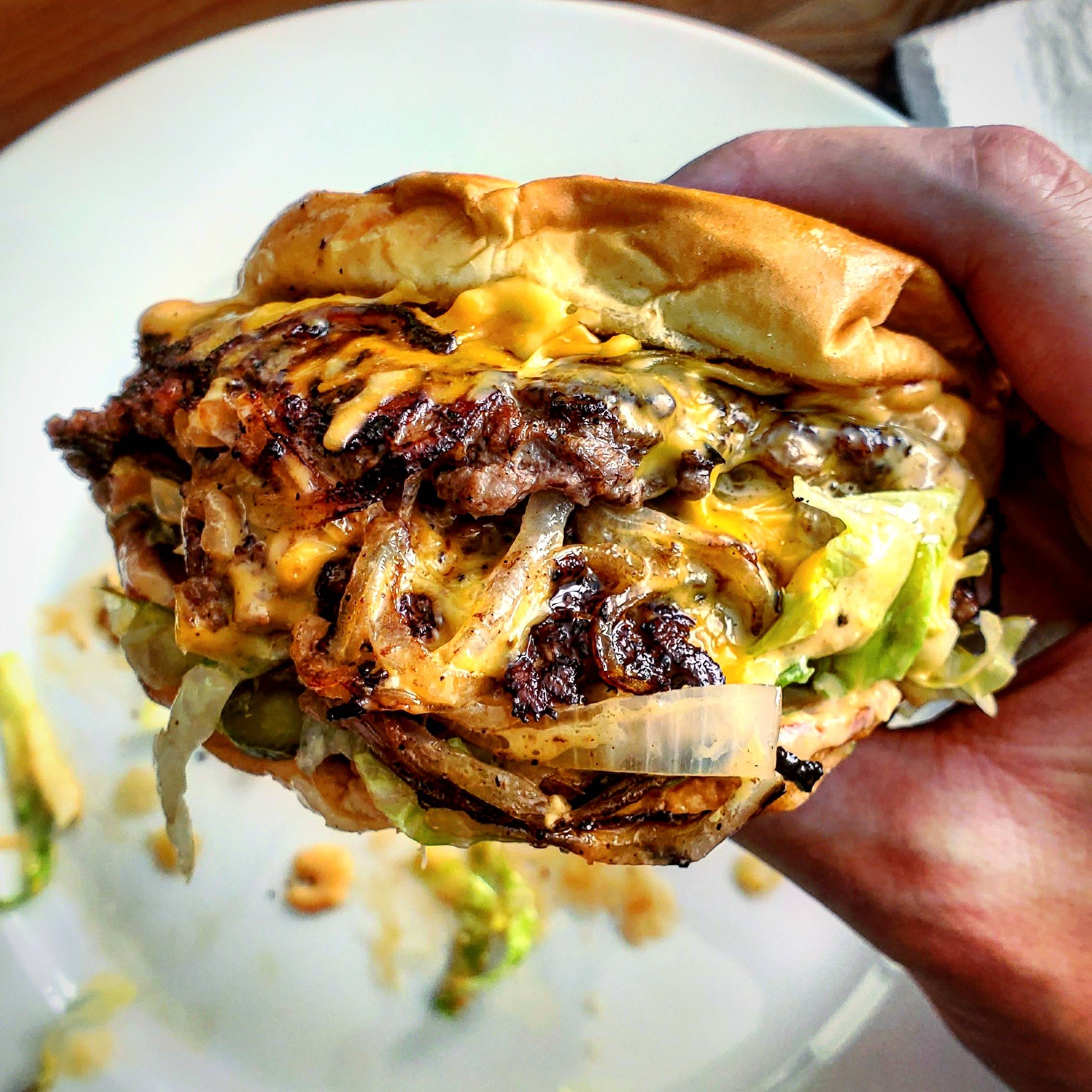 Working on my burger game! This is my double smashed onion burger with sauce, shredduce, and ...