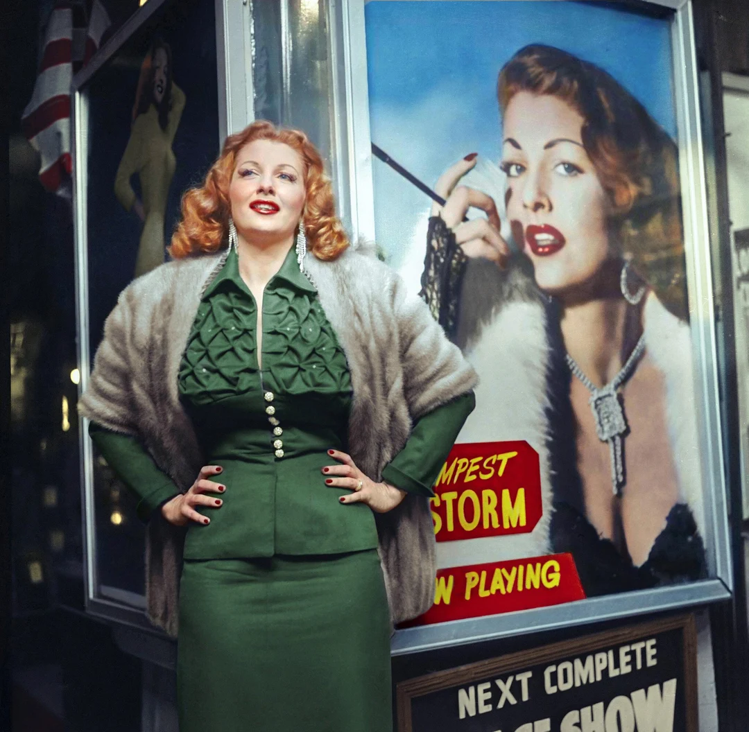 American burlesque Star Tempest Storm poses next to a promotional poster for her burlesque act ...