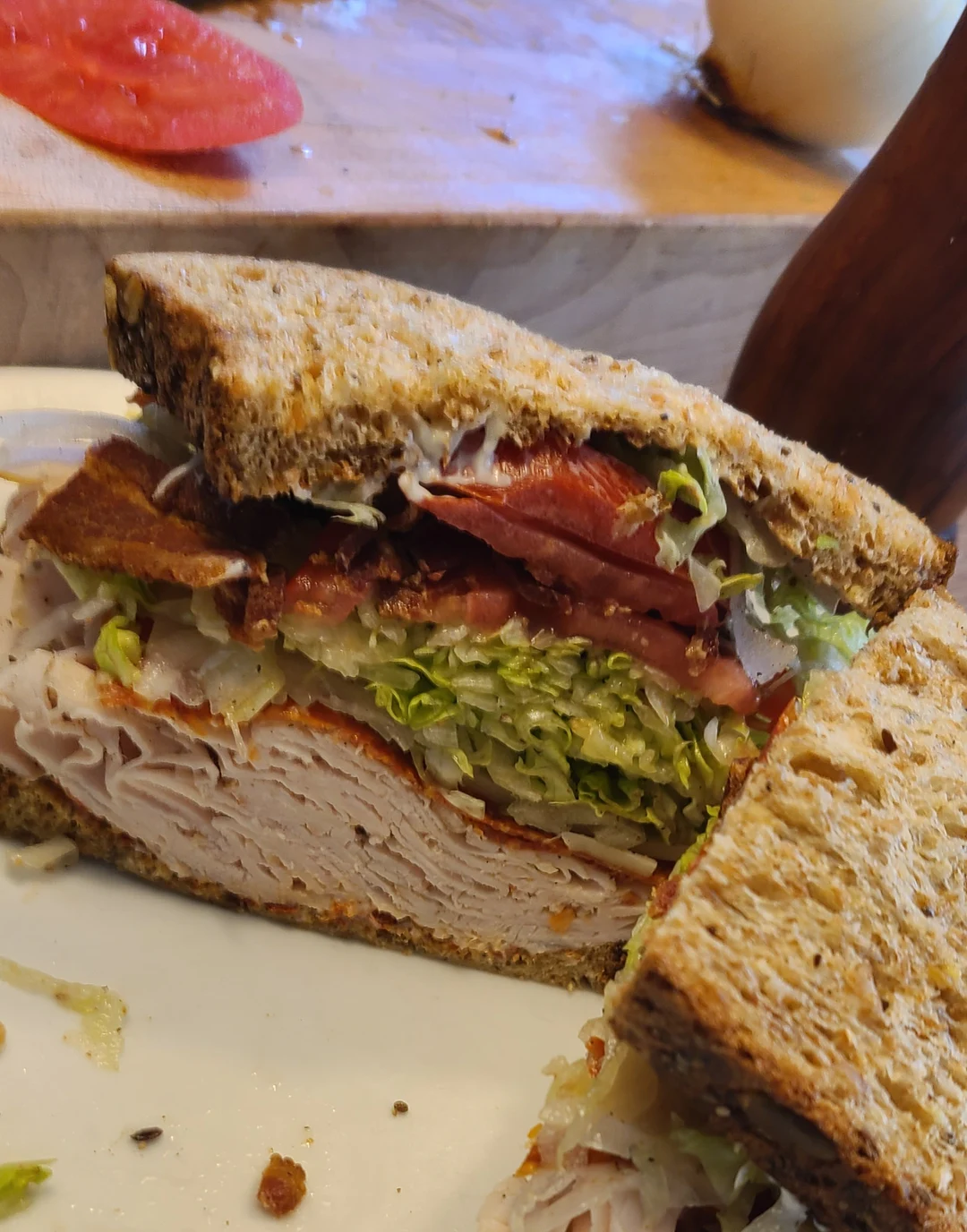 Turkey, Bacon, spicy salami and lettuce, tomato, onion on sprouted wheat. | Scrolller