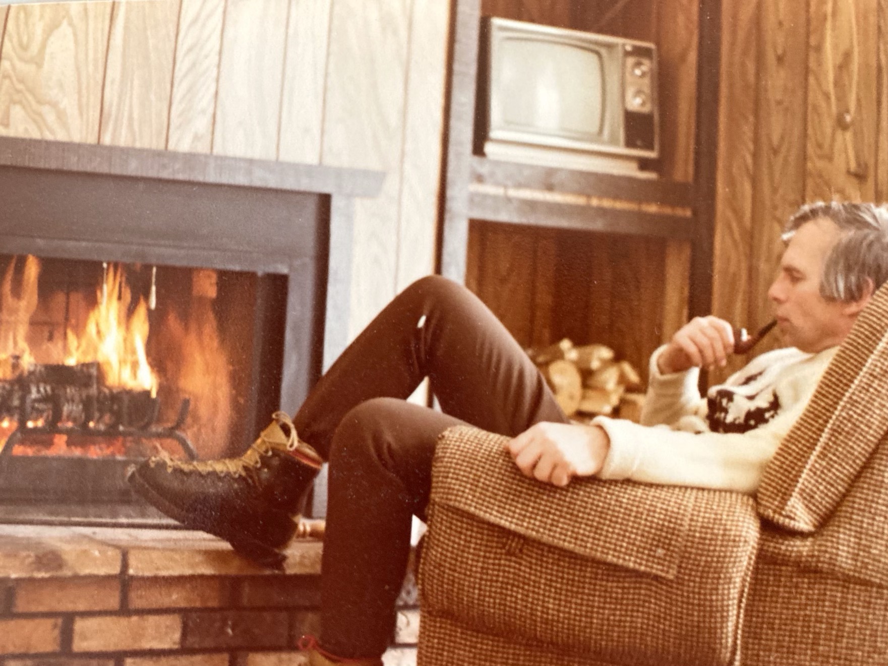 My grandfather enjoying a pipe in the lodge during a ski trip in 1978 | Scrolller