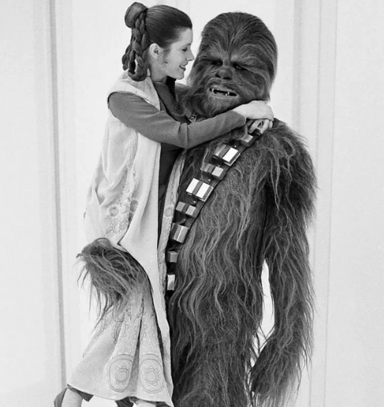 Carrie Fisher with Chewbacca on the set of 'The Empire Strikes Back': 1979 | Scrolller