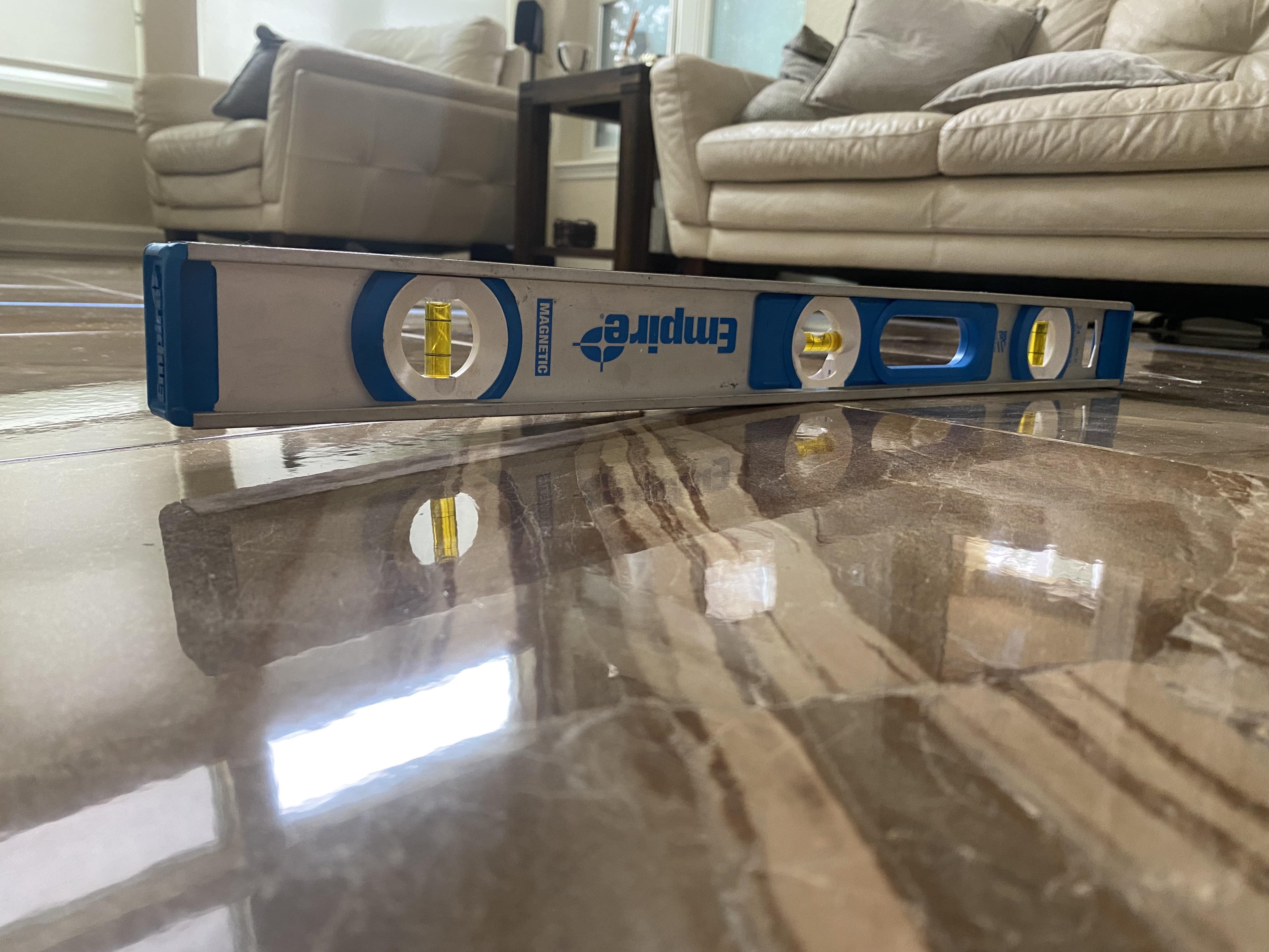 Tile floor lifted to a peak. | Scrolller