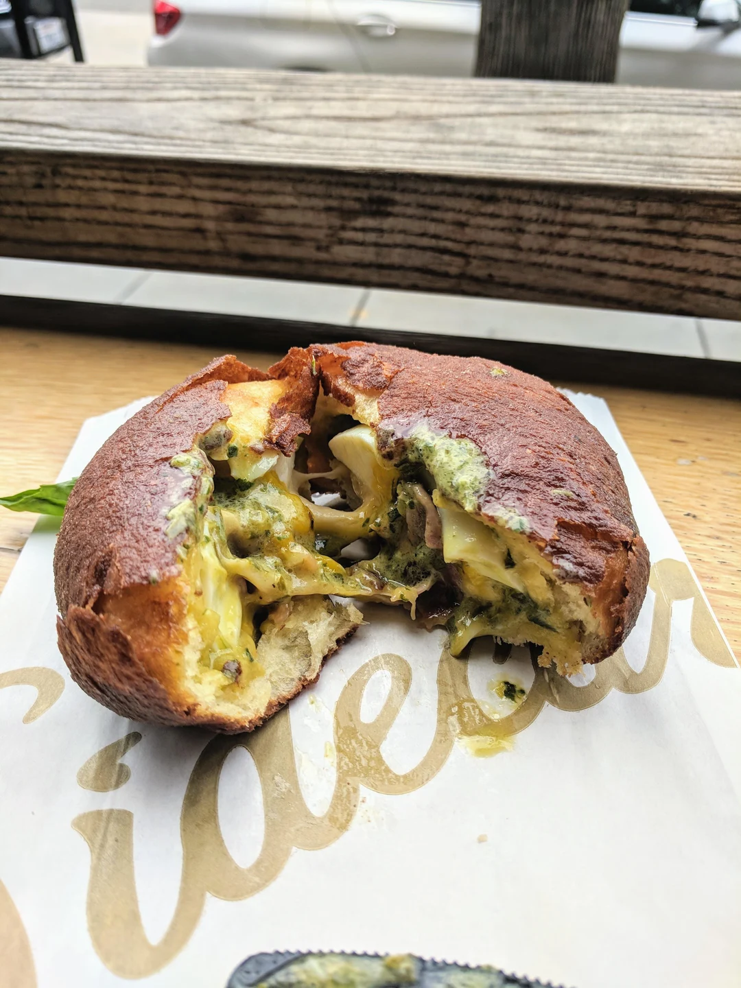 Poached egg, ham, cheese, and basil hollandaise in a fry bread | Scrolller