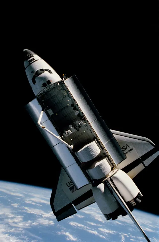 Space Shuttle Challenger floating freely in orbit above Earth, as seen by Bruce's helmet camera ...