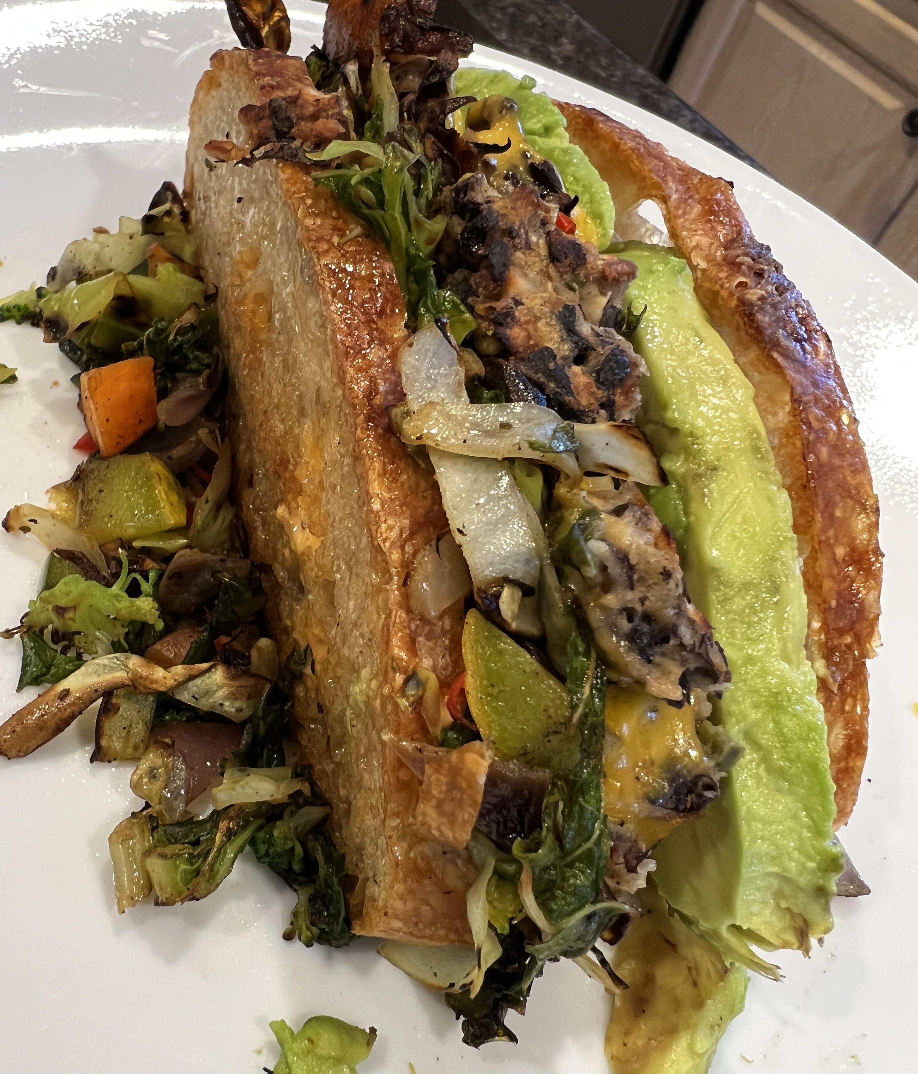 [homemade] sandwich with veggie burger patty, avocado, pan seared mixed vegetables and kimchi ...