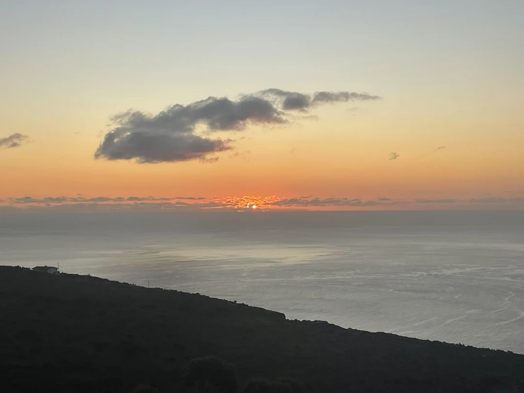 Sun setting through the clouds over St Helena | Scrolller