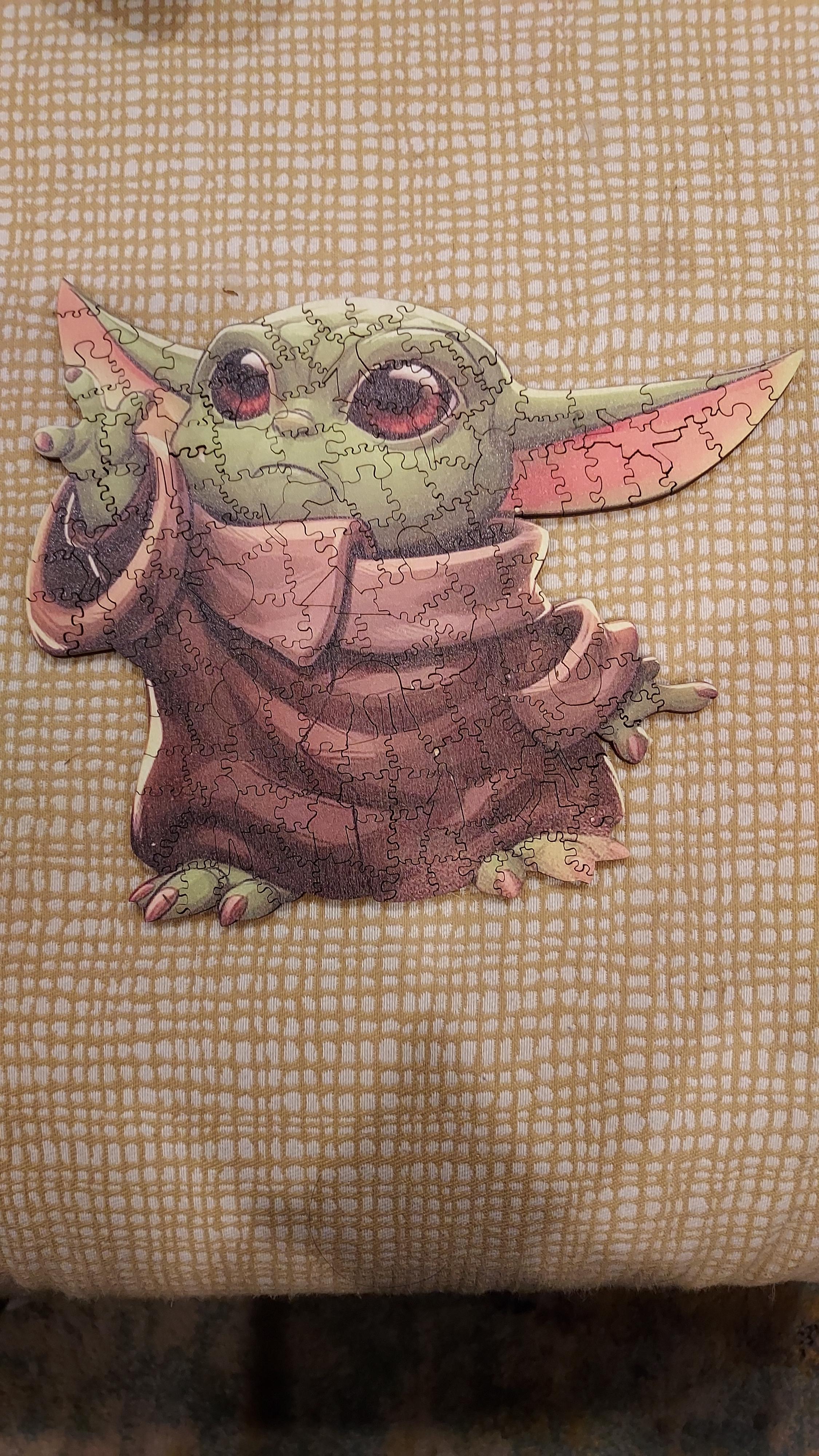 Finished this Grogu puzzle. Notice some of the shapes of the pieces. | Scrolller