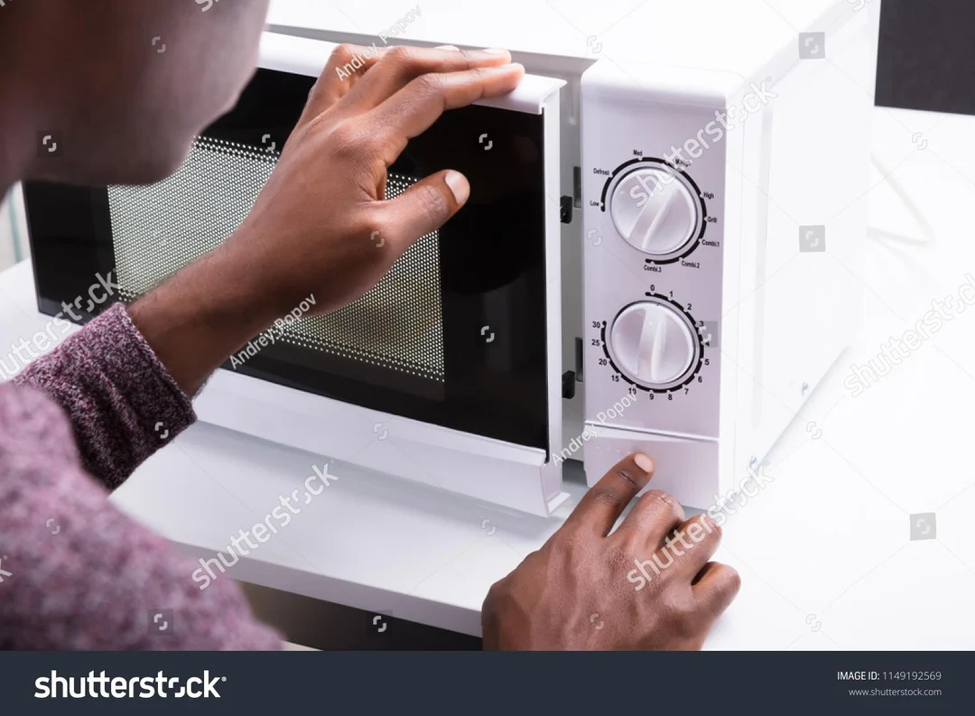 Me stopping the microwave and opening it for the stock photo shoot | Scrolller