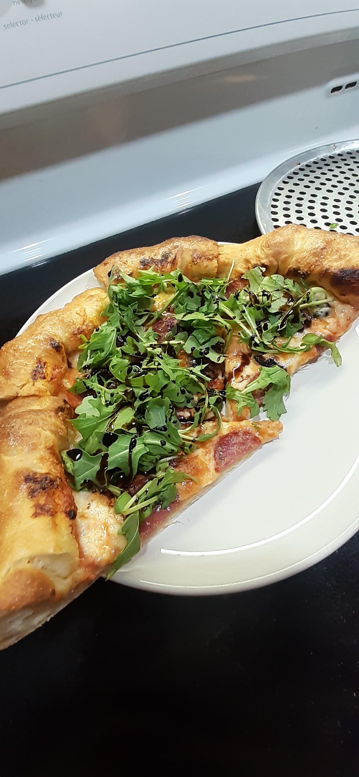Tried new york style with a cheese stuffed crust, olives, wine dry sausage, rocket and balsamic ...