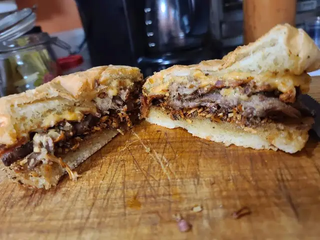 Quick Steak and Bacon Melt with Beer Cheese on a bed of Crispy Onions and Garlic | Scrolller