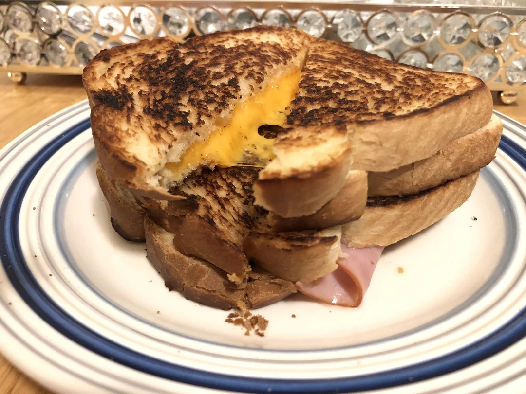 Crispy Classic. White bread, Butter, Cheddar. On top of a ham cheddar melt. | Scrolller