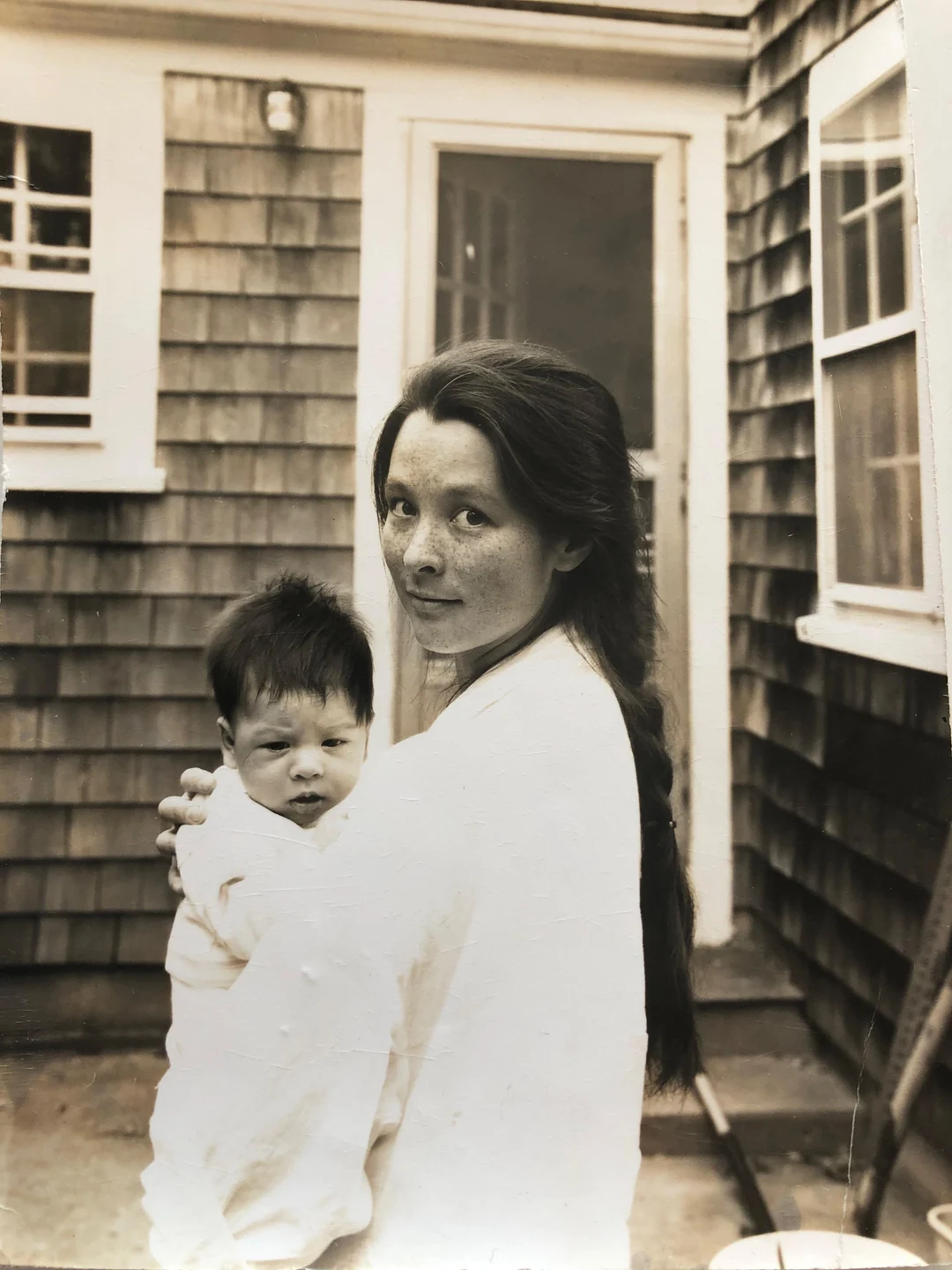 My mother and 2 week old me outside my grandmother's house, 1986 | Scrolller