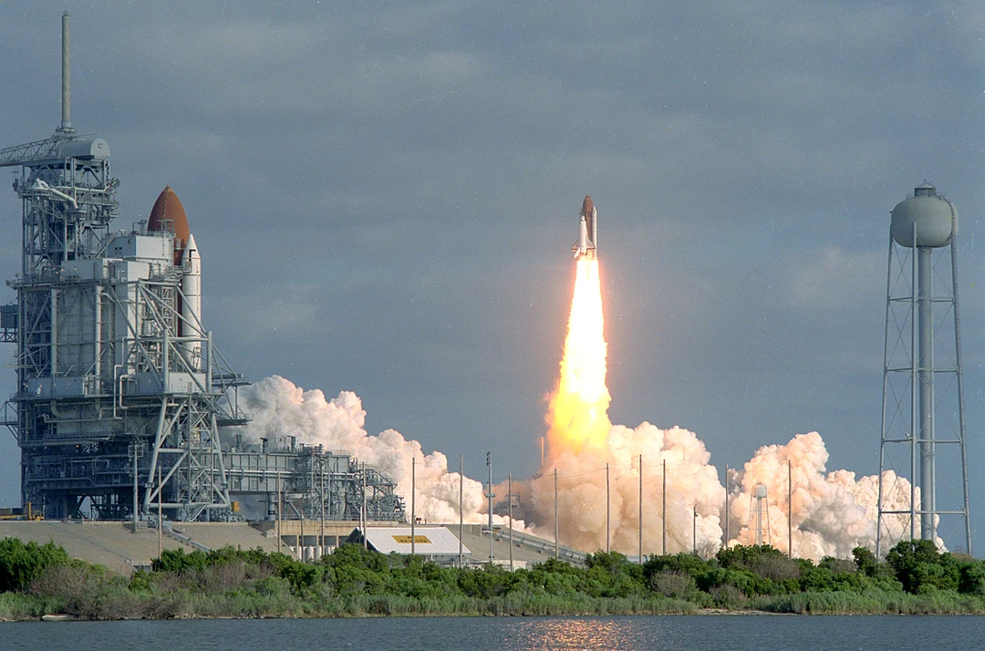 Space Shuttle Discovery, carrying the Hubble Space Telescope, launches from LC-39B for mission ...