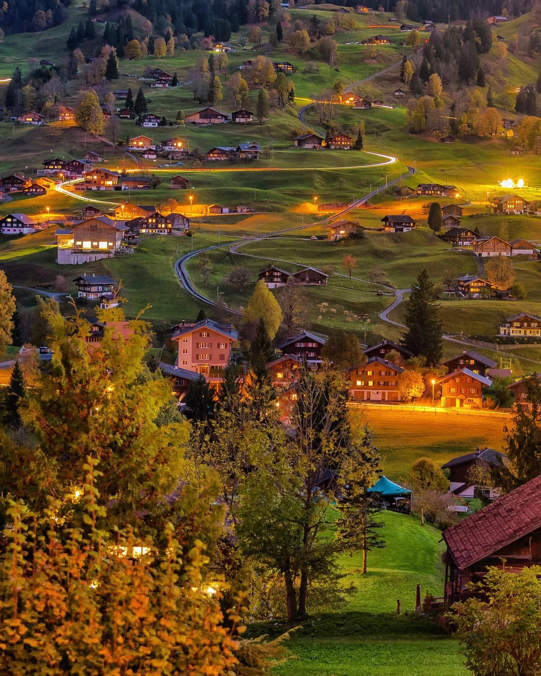 Chalets on the rolling green hills of Grindelwald, Canton of Bern, Switzerland. | Scrolller