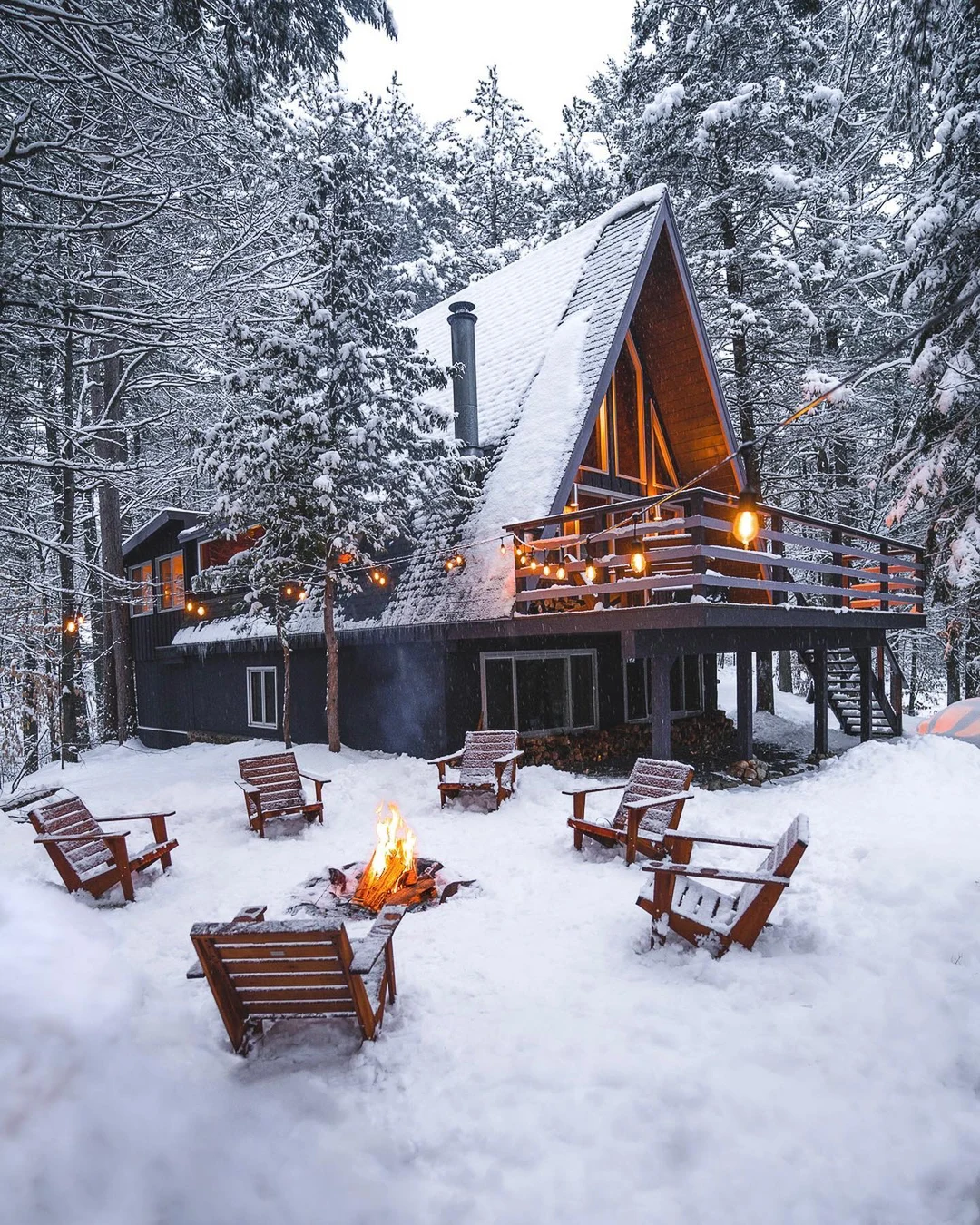A-frame cabin surrounded by the winter forest in Adirondack Park near Lake Placid, the ...