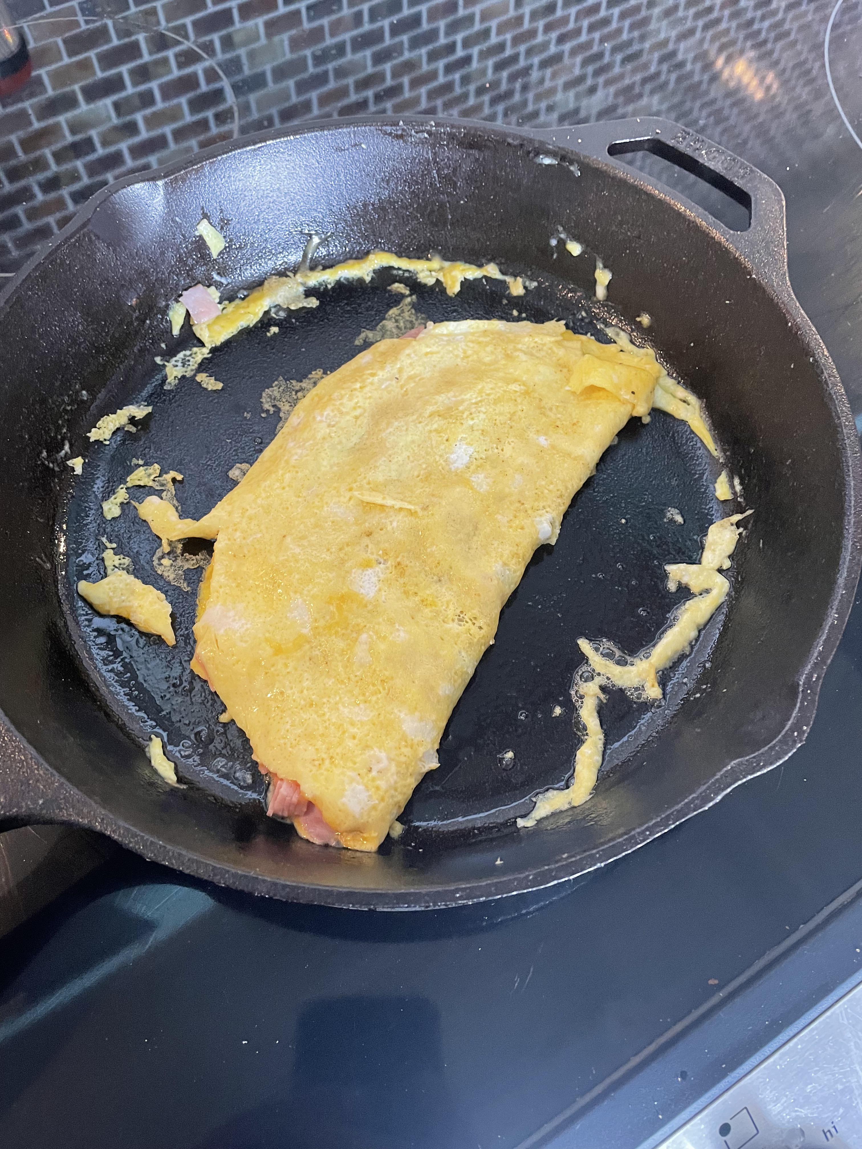 First attempt at an omelet in my cast iron. No slidey porn but she held together nicely. | Scrolller